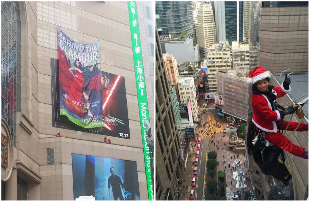 Rebel 'Santas' abseil down Times Square TV to raise awareness of ...