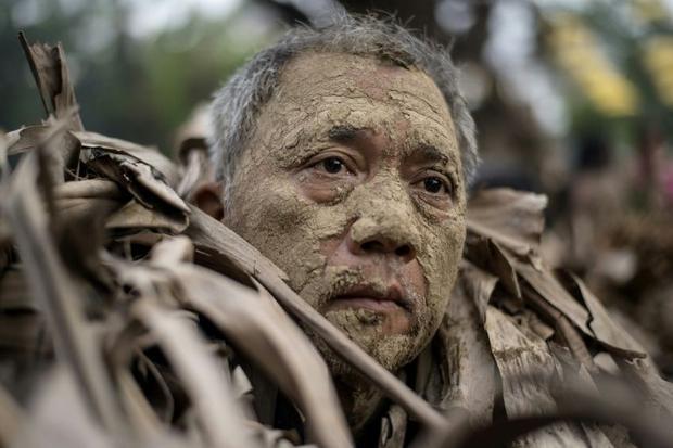 Quite a mud-dle! Filipino devotees slather themselves in mud for annual ...